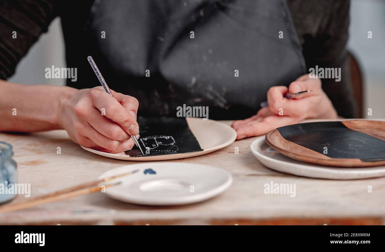 Woman decorating plate handmade hi-res stock photography and images - Alamy