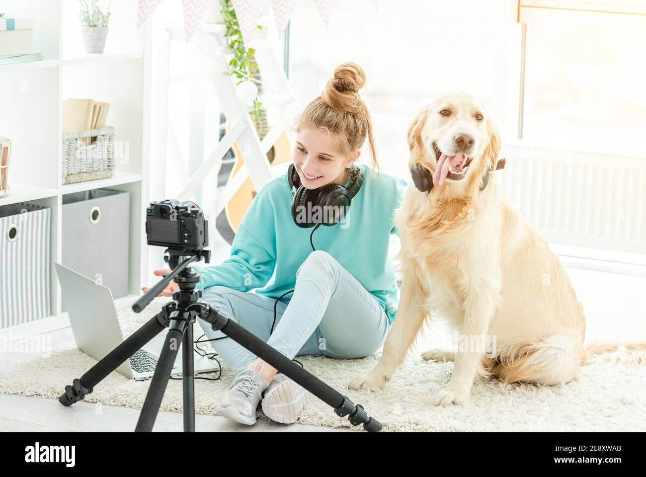 Cute teenage girl with dog blogging Stock Photo - Alamy