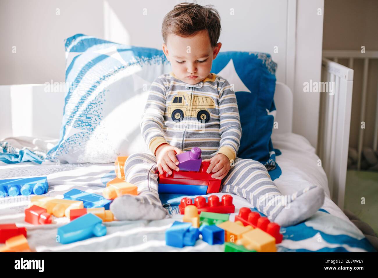 Cute baby toddler playing building with learning toy stacking blocks at ...