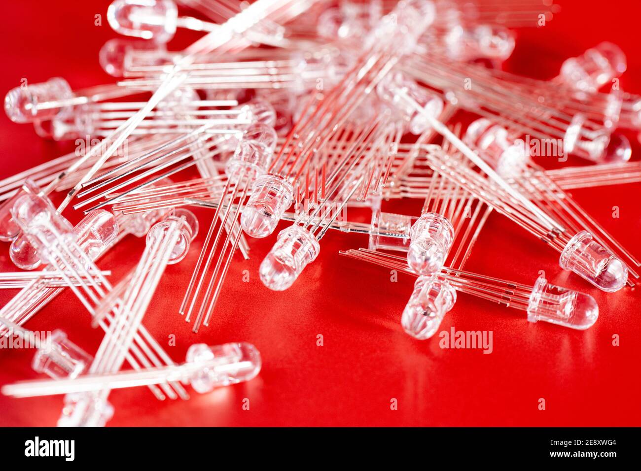 Pile of white LED diode on red background. Electronic components and ...