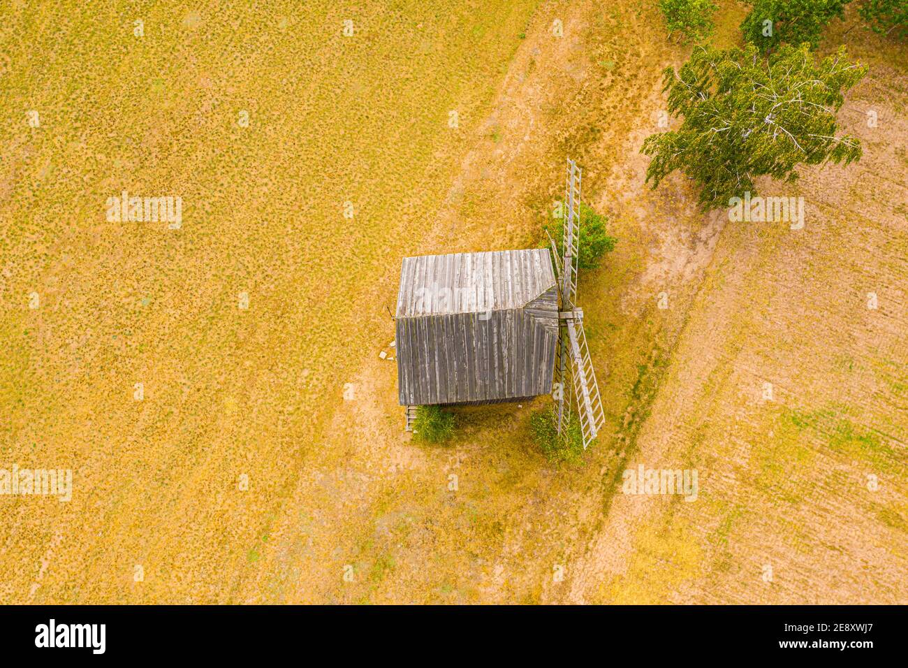 Close up old wooden mill blades. Bright sky of the setting sun. Small ...