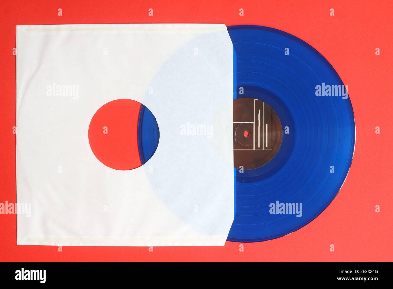 Aged White paper cover and blue vinyl LP record isolated on Red ...