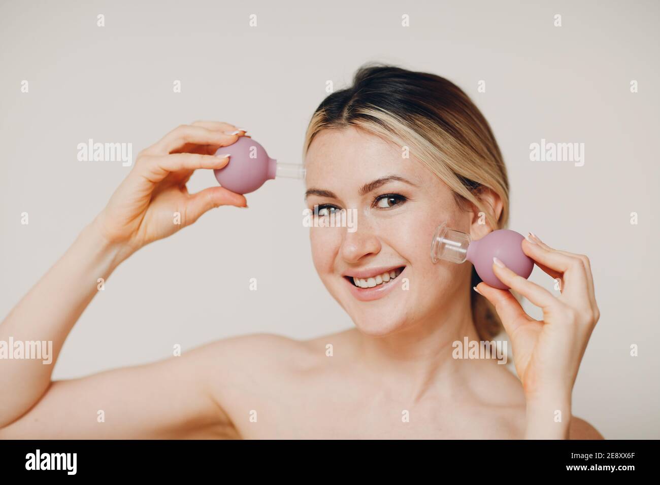 Cupping therapy procedure, woman with little medical cup for face Stock ...