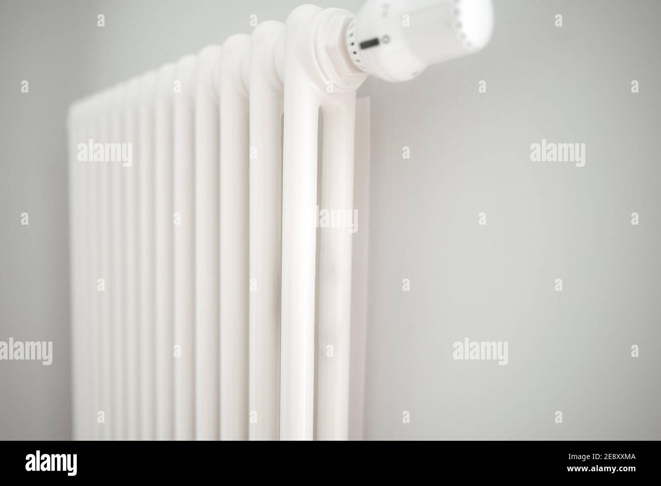 a white radiator on a white wall Stock Photo - Alamy