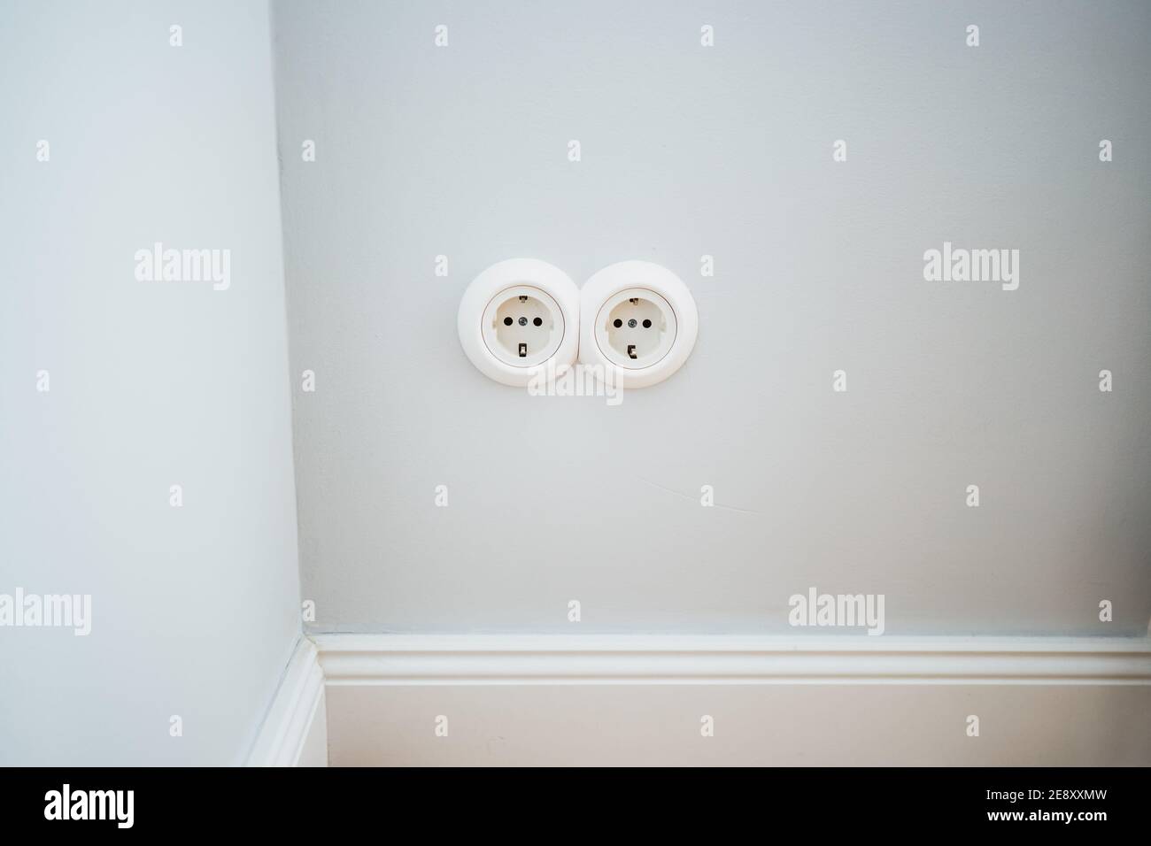 a white electricity socket on a white wall Stock Photo - Alamy