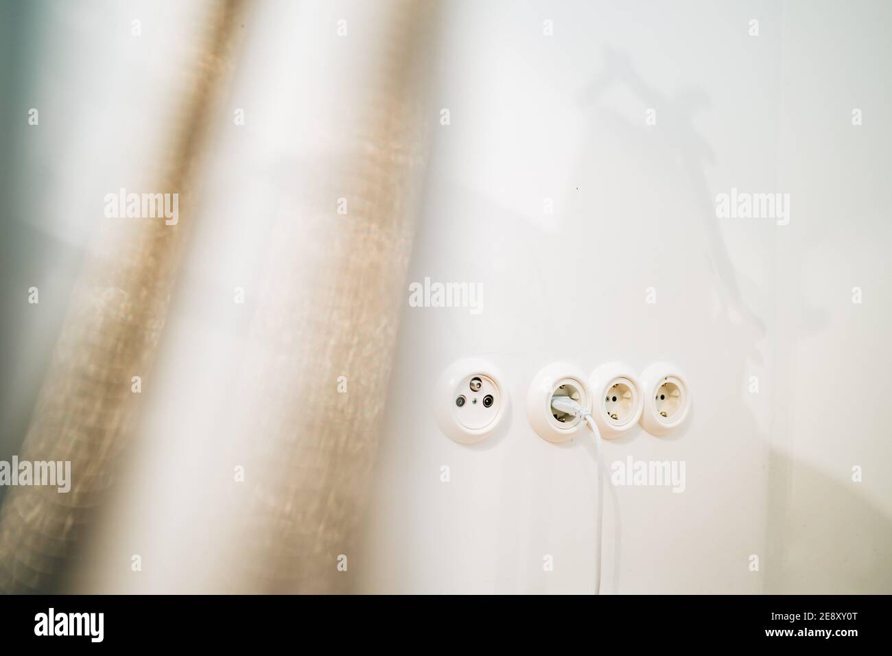 electricity socket on a white wall in the house Stock Photo - Alamy