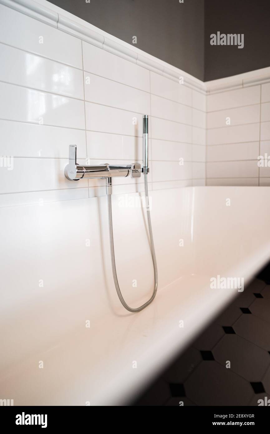 a close up of a modern black bathtub tap Stock Photo - Alamy