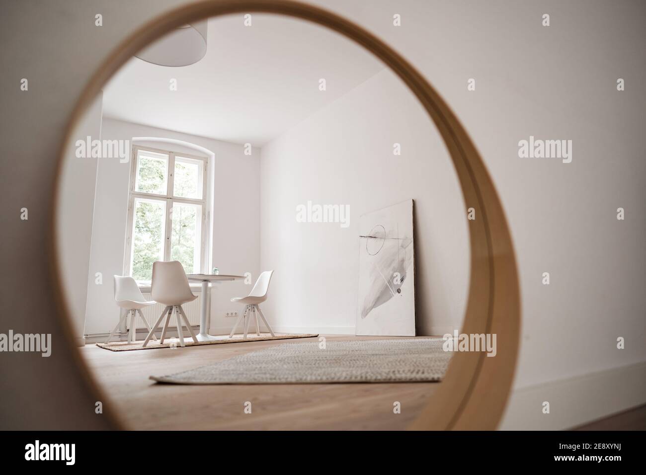 a modern dining table reflection in a mirror Stock Photo - Alamy