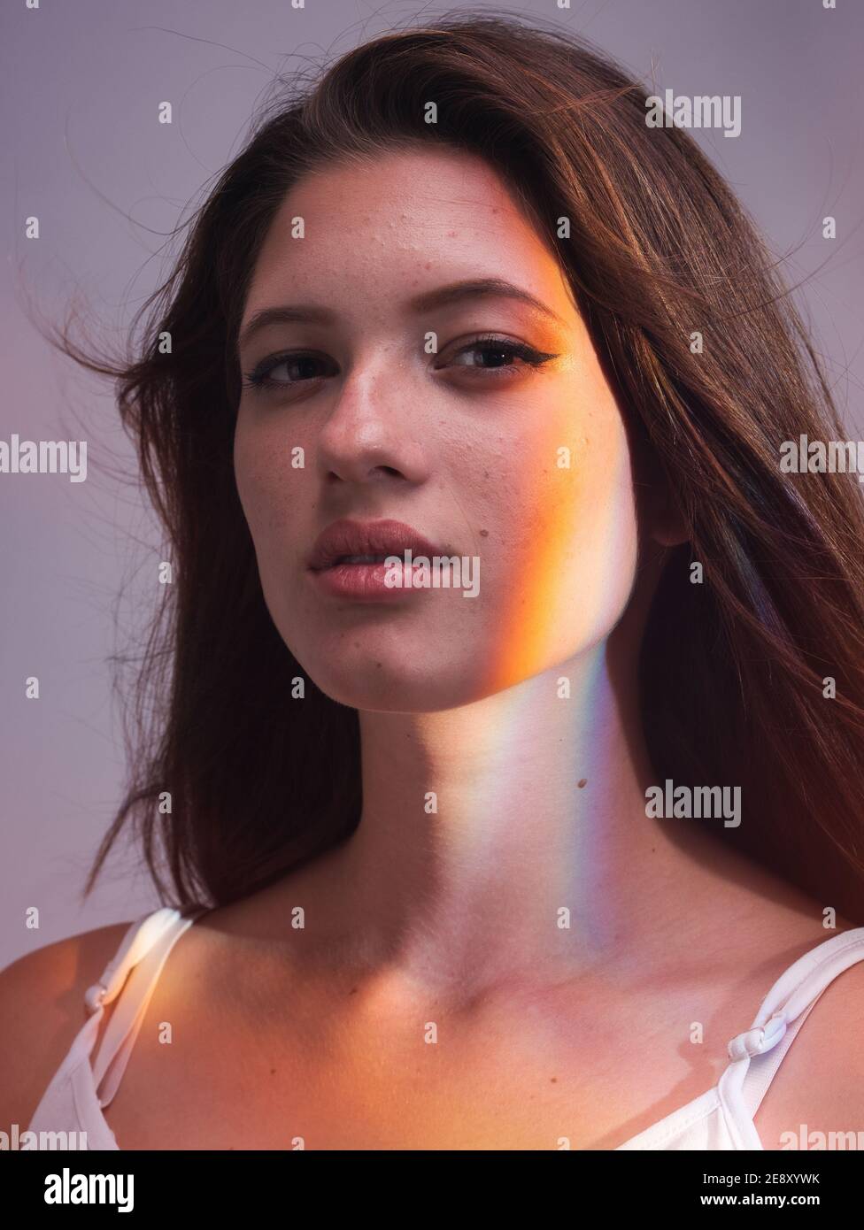 portrait of one young woman, posing in photo studio with white ...