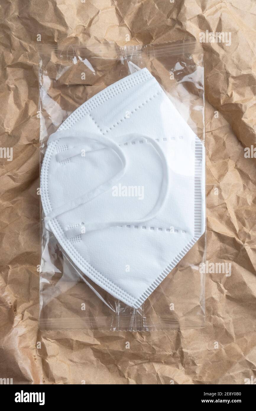 New protective white medical breathing protection mask on a crumpled ...