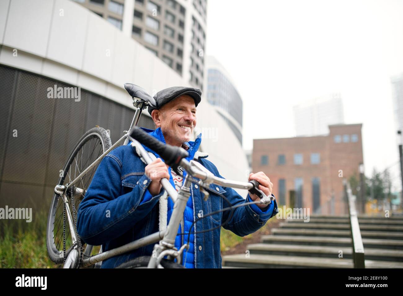 Man carrying bicycle hi-res stock photography and images - Alamy