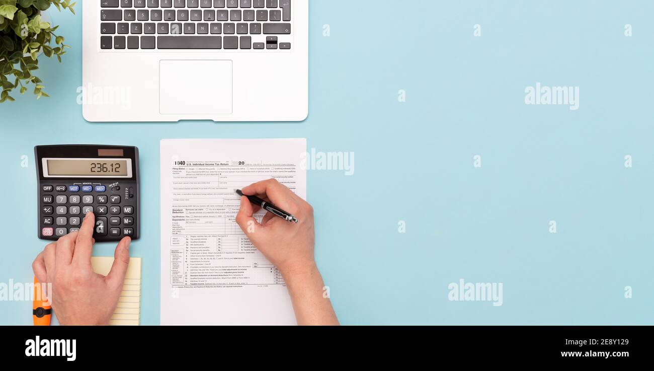 Tax income concept with US tax form. Accountant filling documents on ...