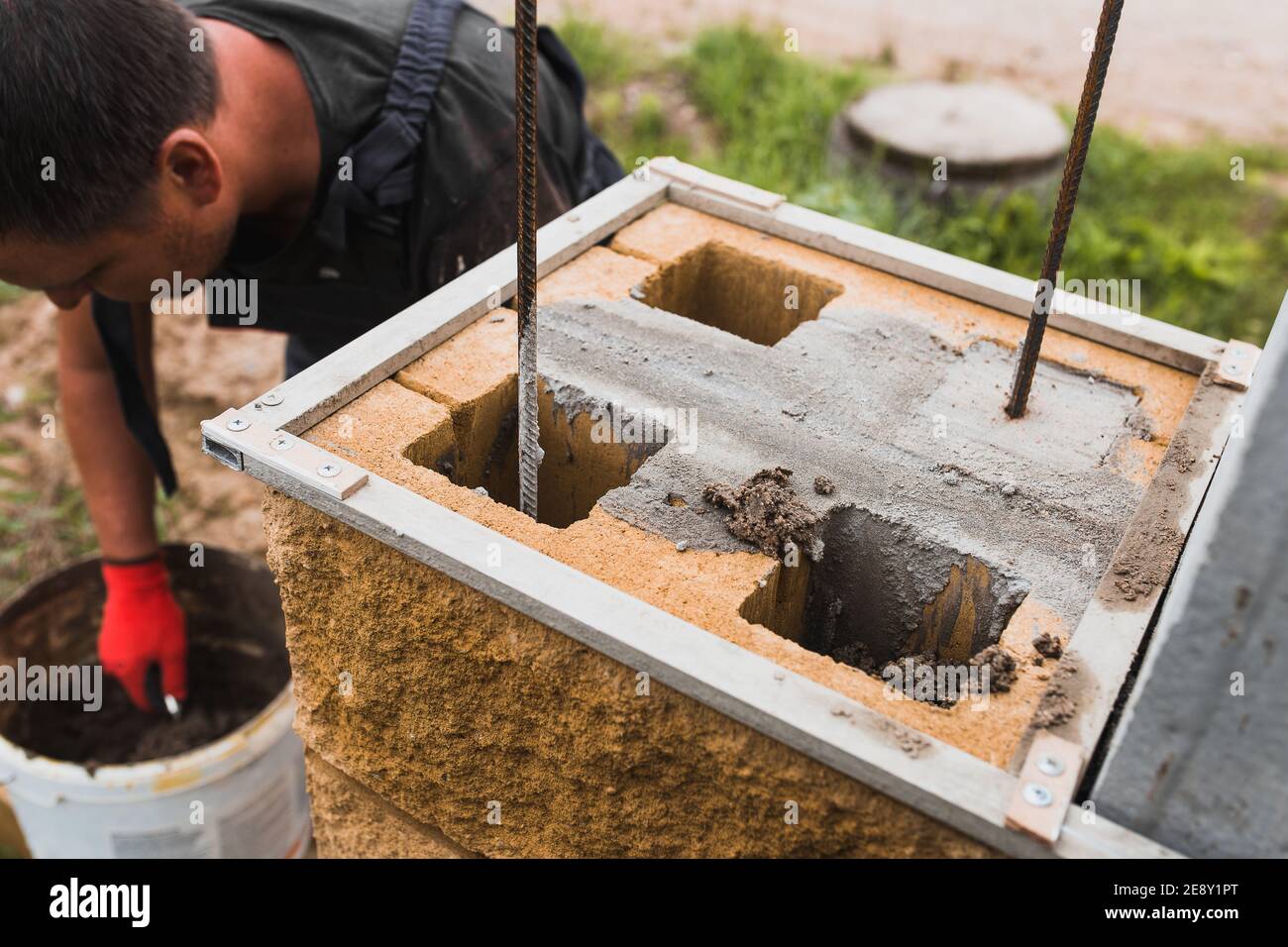 A man builds a house for a family - masonry walls - suburban housing ...
