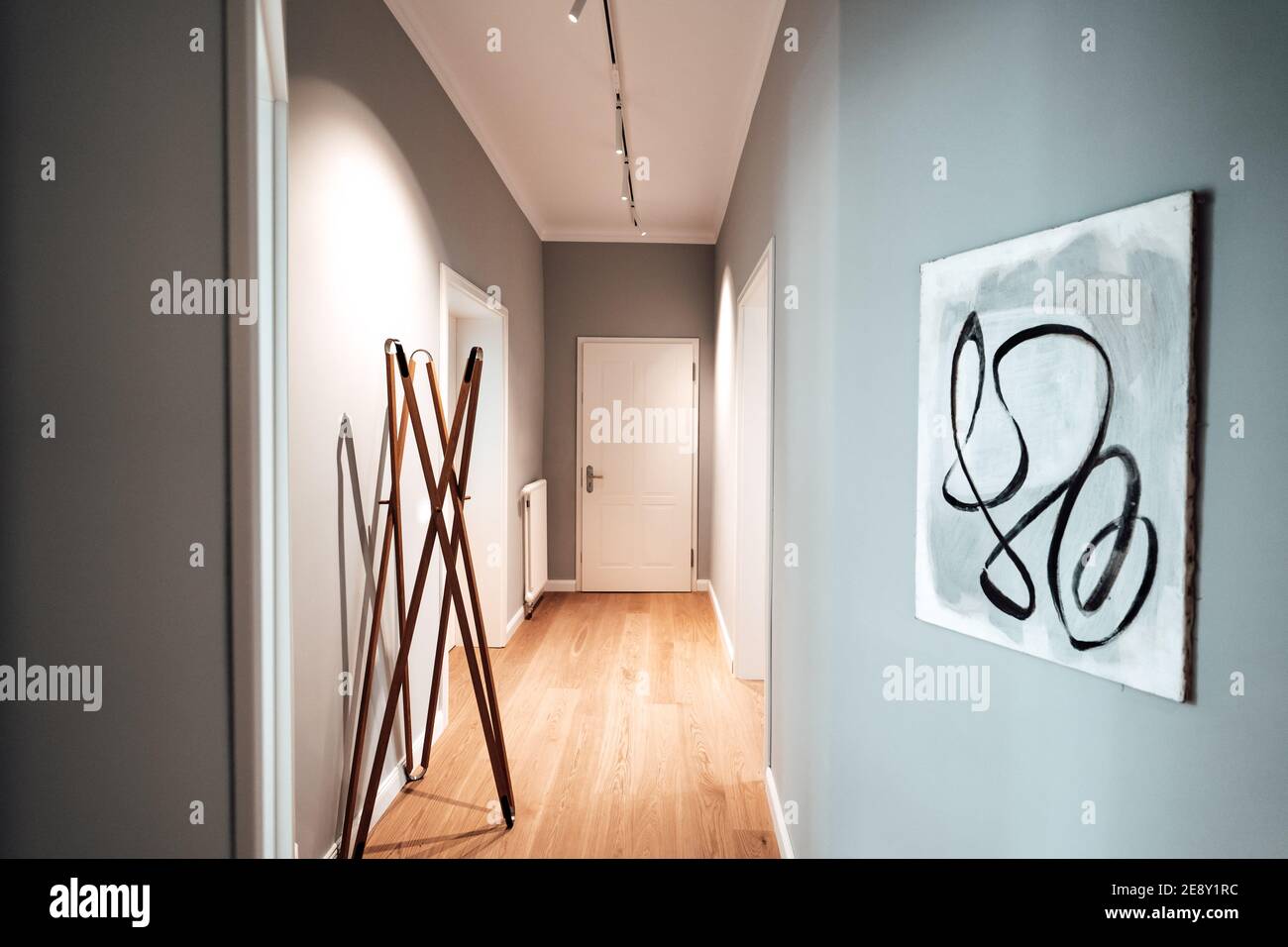 a corridor in an apartment with a painting on the wall Stock Photo - Alamy