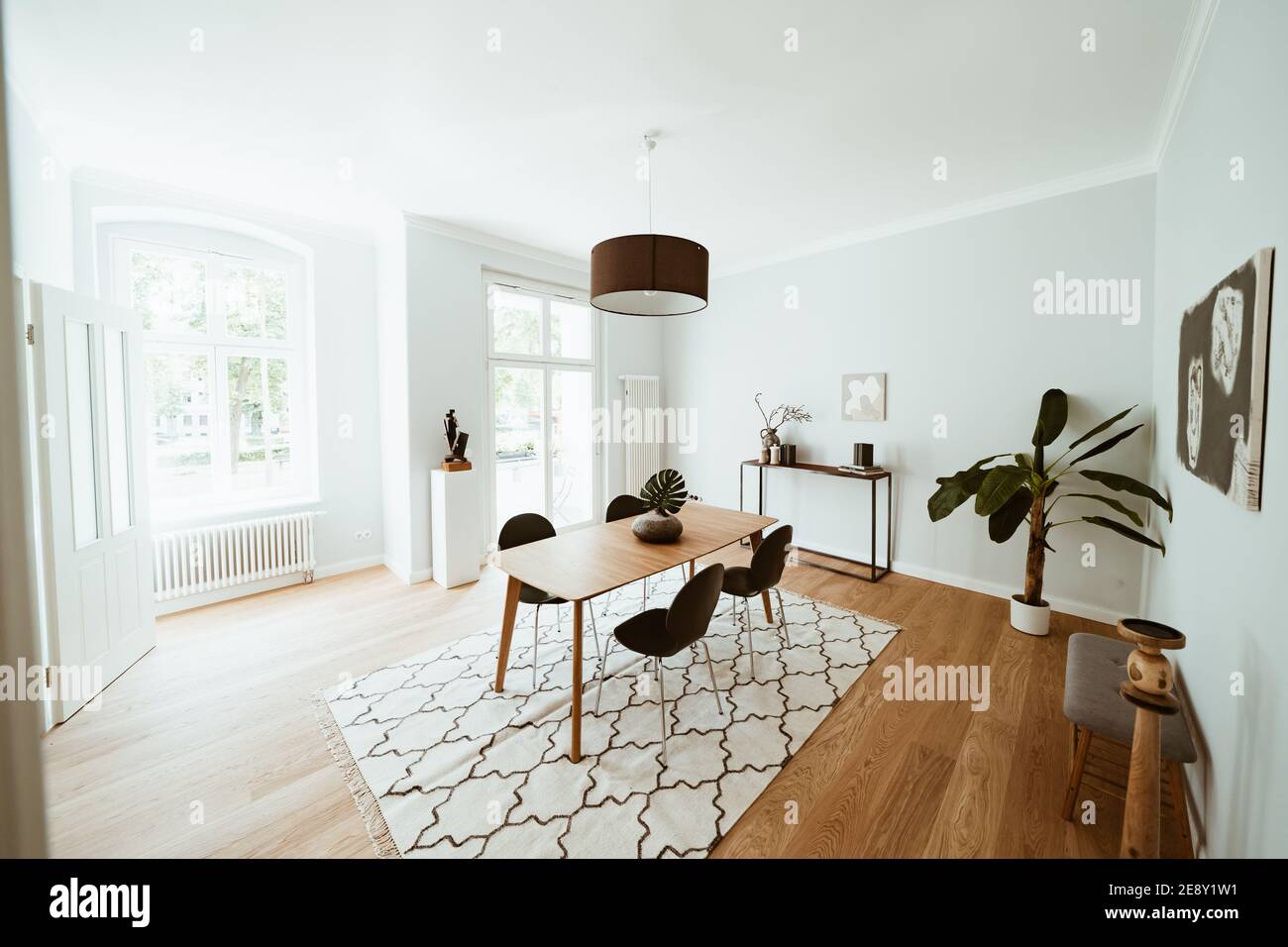 photo of an open-plan white dining room interior Stock Photo - Alamy