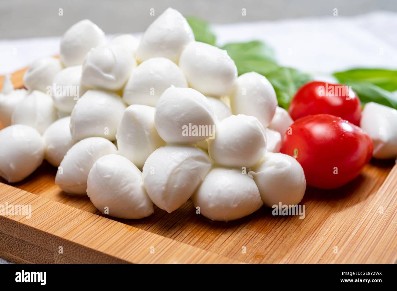 Italian food, fresh fresh green basil, white mini mozzarella cheese and ...