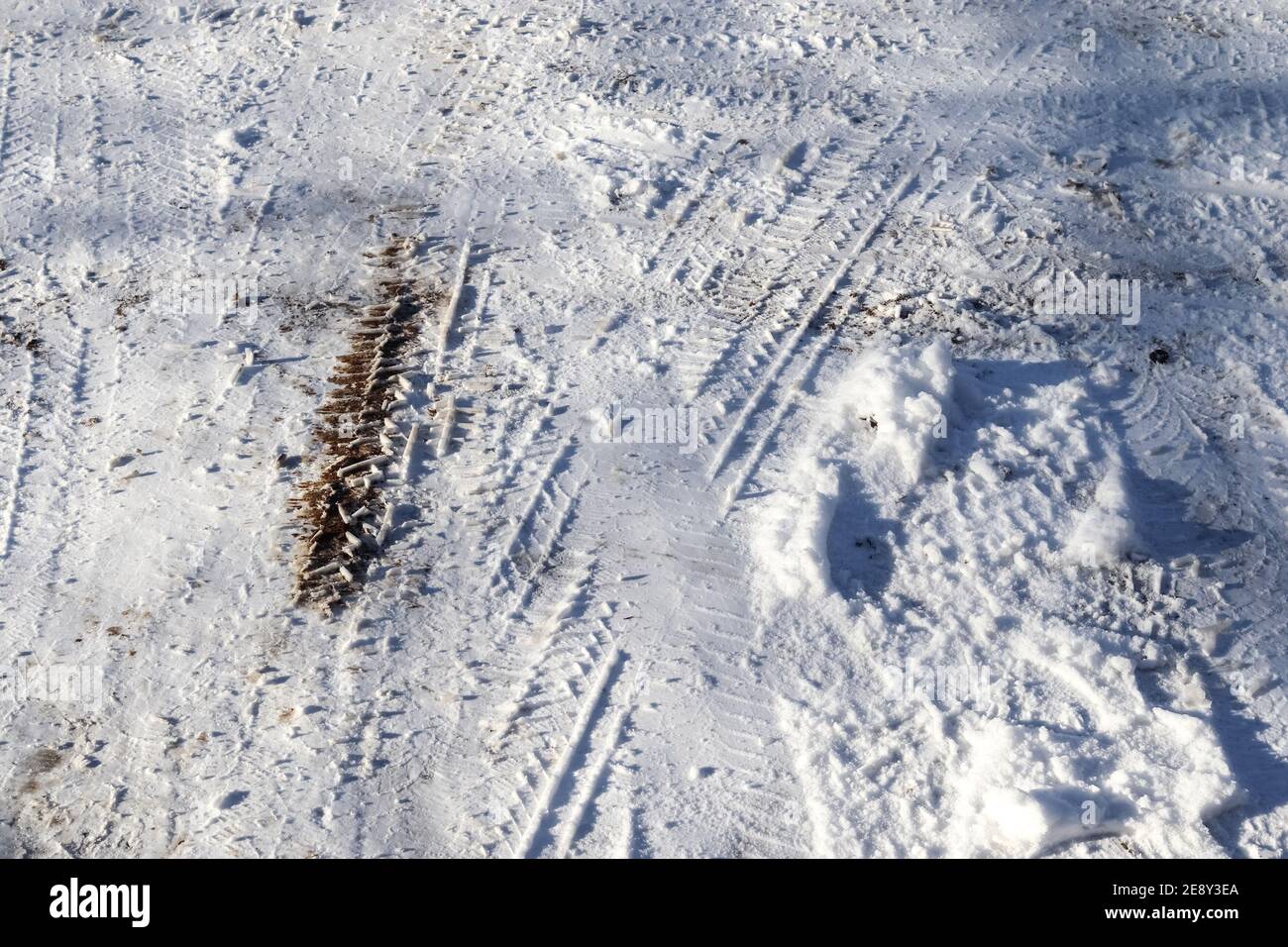 Tire Tracks on snow covered streets in a close up view Stock Photo - Alamy