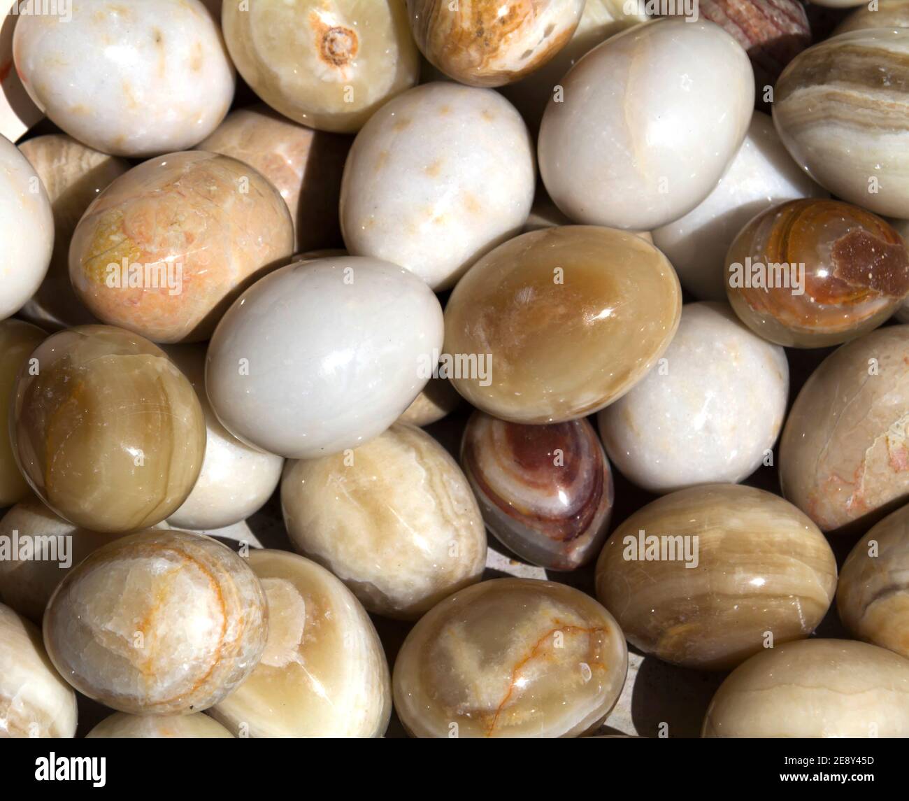 Egg shaped rocks piled together Stock Photo - Alamy