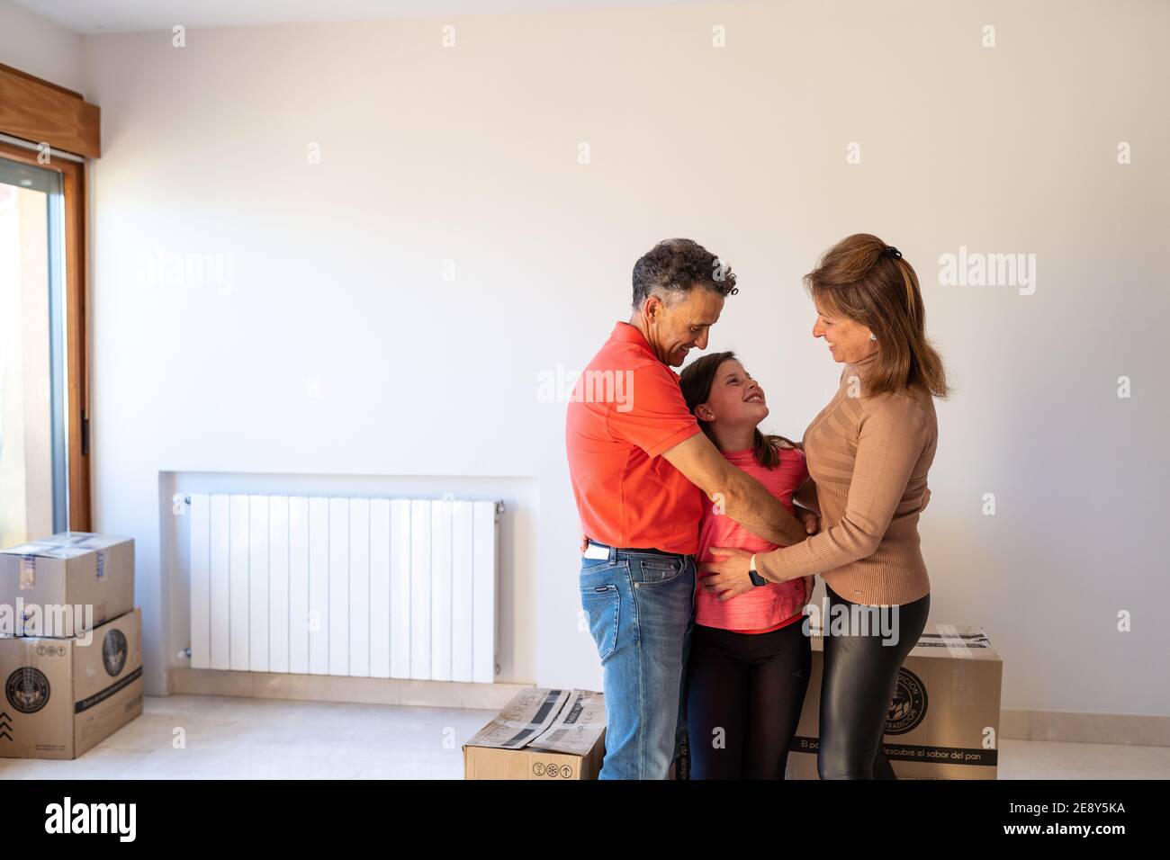 Happy family smiling at each other because they are moving into a new ...