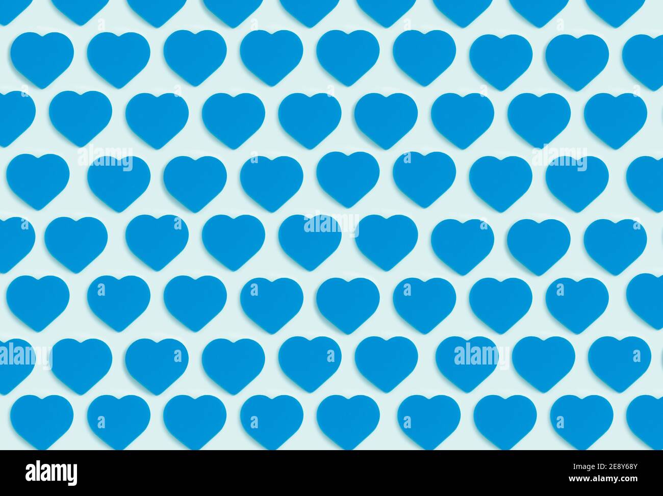 Hearts background. Colored ornament pattern from cut out blue hearts on ...