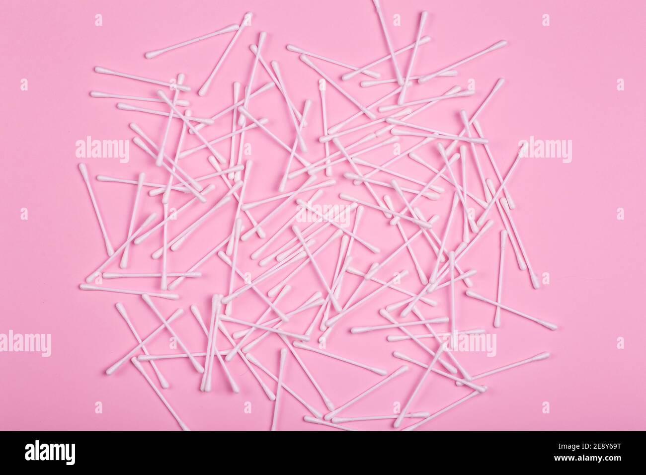 Plastic hygiene sticks on a pink background. Plastic pollution and ...