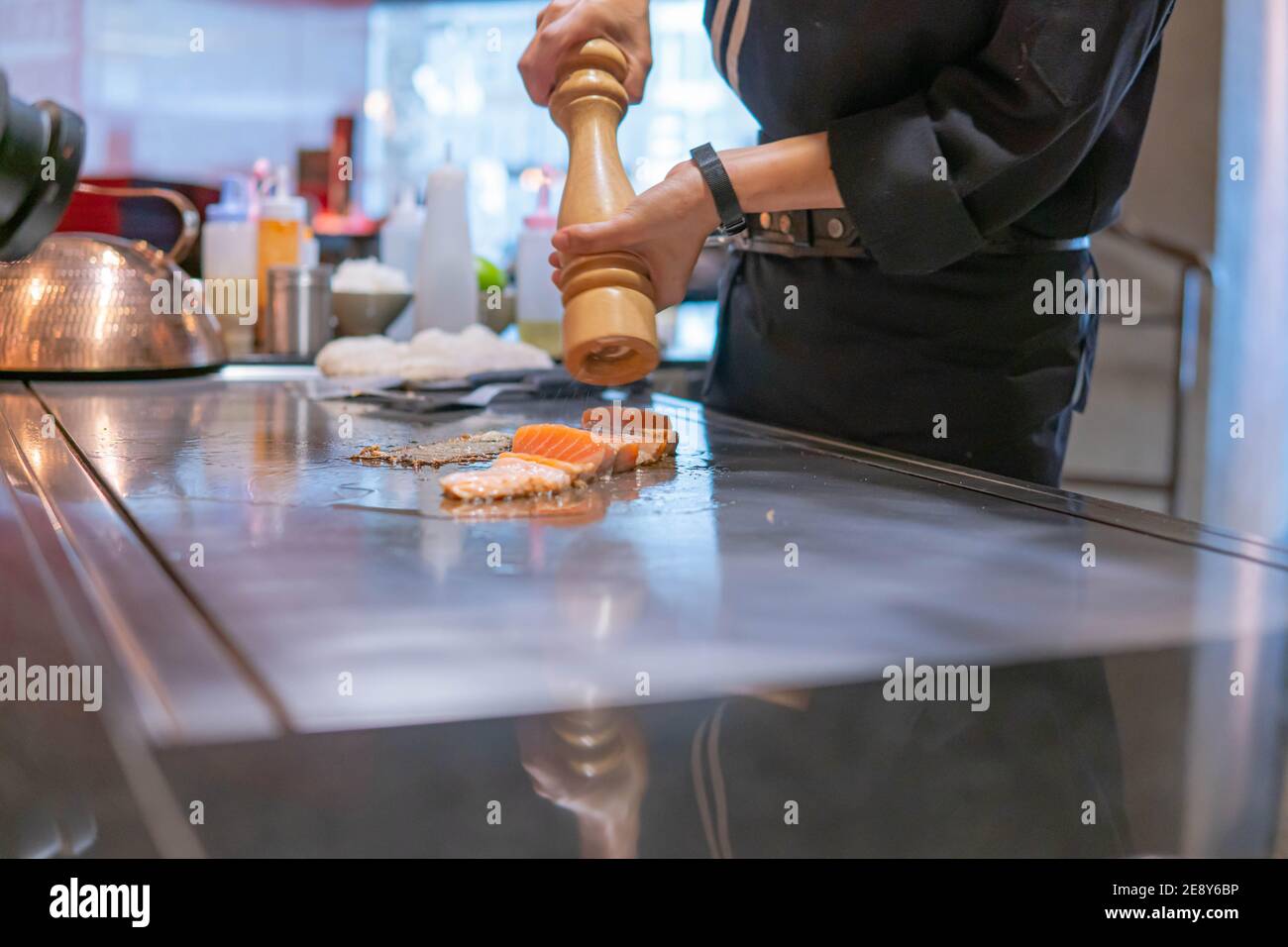 Hand of Chef cooking salmon steak Stock Photo - Alamy