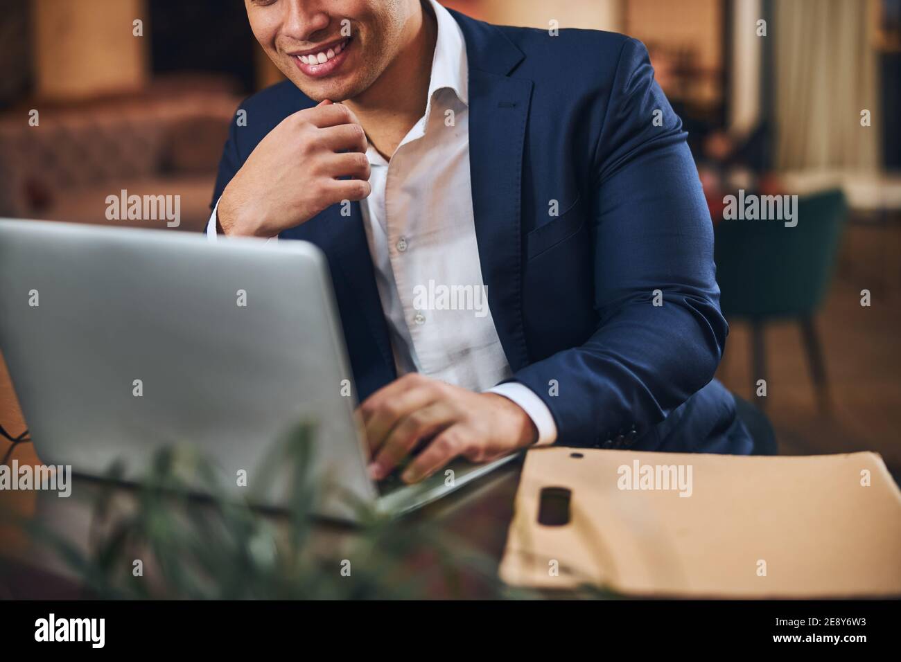 Joyous male entrepreneur seated at his computer Stock Photo - Alamy
