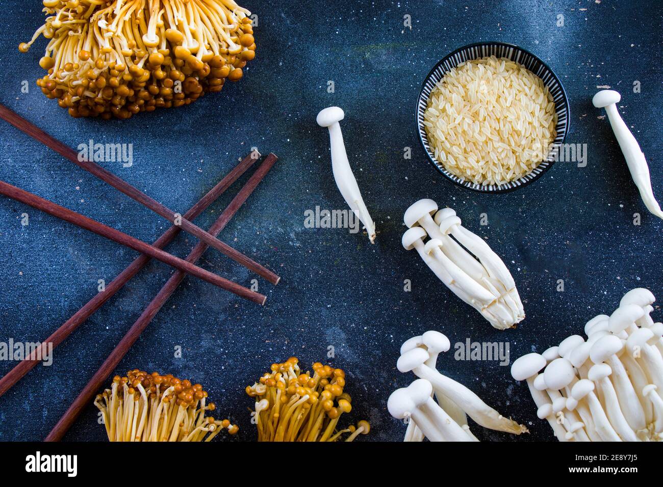 Golden brown and white Asian Enoki mushrooms, vegetable background ...