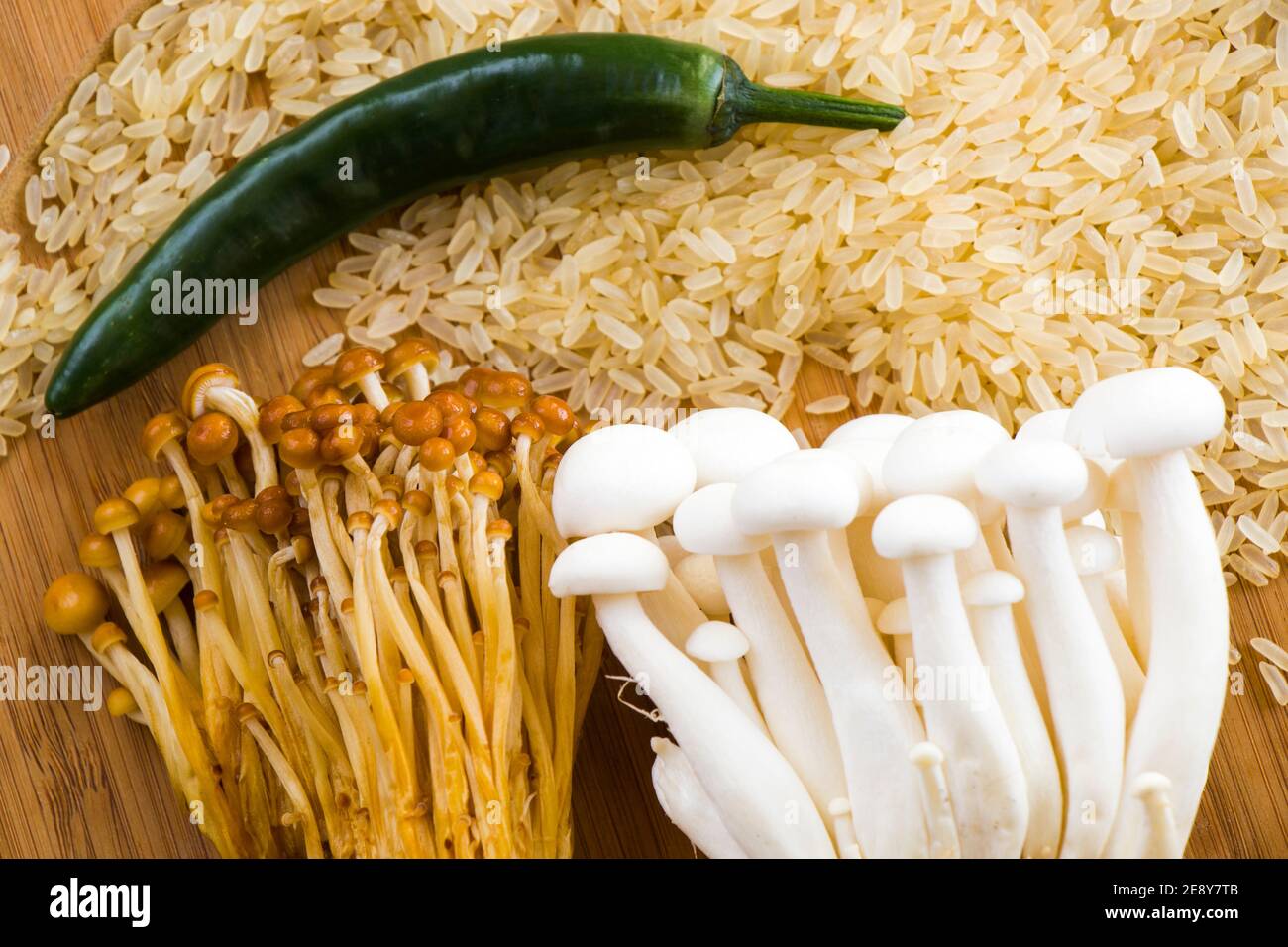 Golden brown and white Asian Enoki mushrooms, vegetable background ...
