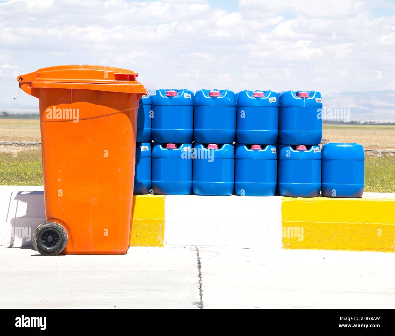 Blue chemical barrels stacked up Stock Photo - Alamy
