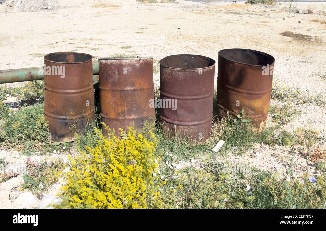 Old empty rusty barrels on a village road Stock Photo - Alamy