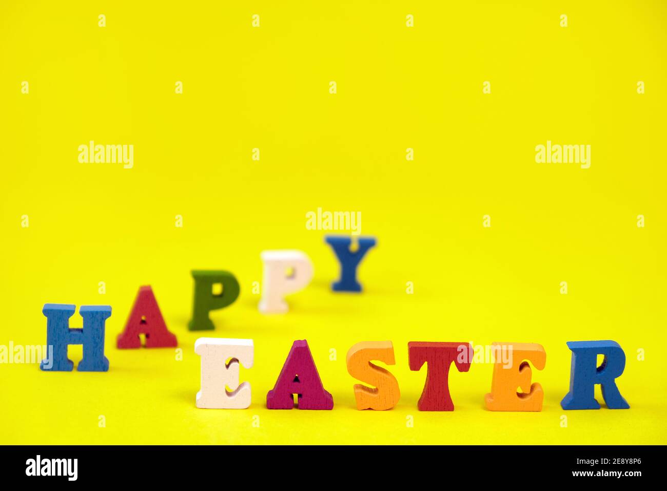 Word Happy Easter of colorful toy alphabet letters isolated on yellow ...