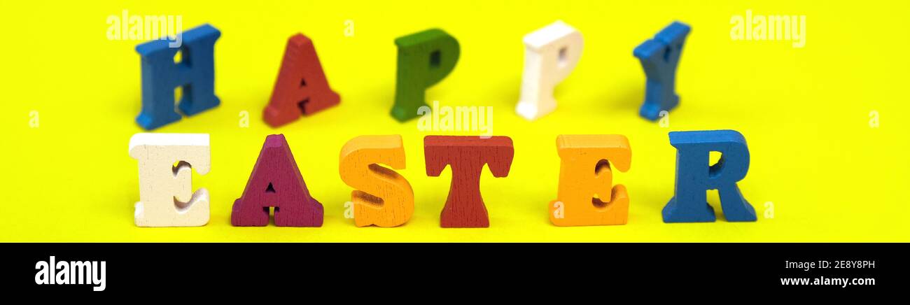 Word Happy Easter of colorful toy alphabet letters isolated on yellow ...