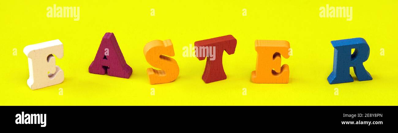 Word Easter of colorful toy alphabet letters isolated on yellow ...