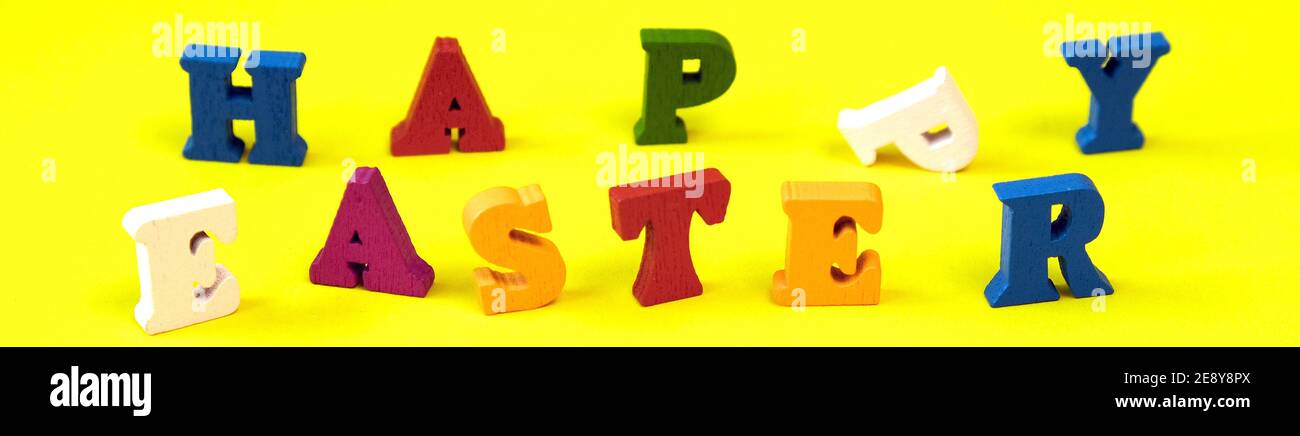 Word Happy Easter of colorful toy alphabet letters isolated on yellow ...