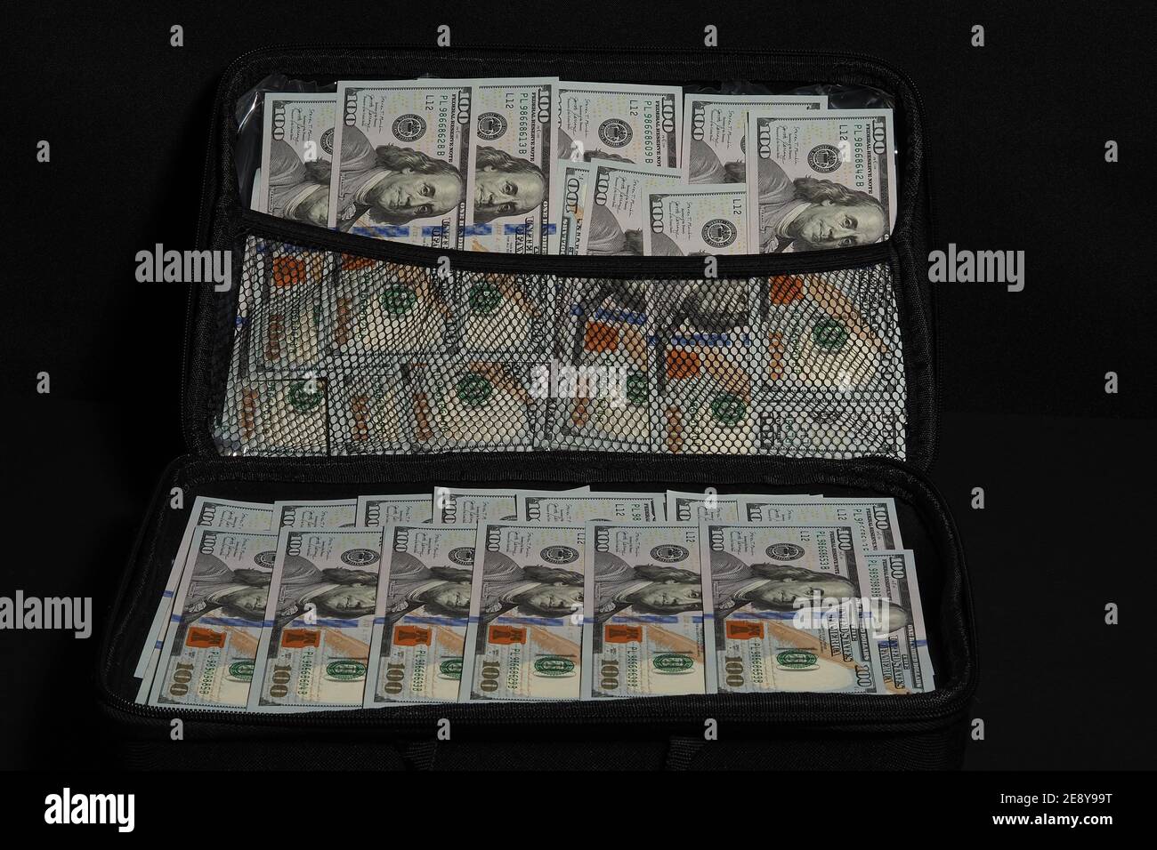 Packs of money in a suitcase. American dollar, a hundred dollars bill ...