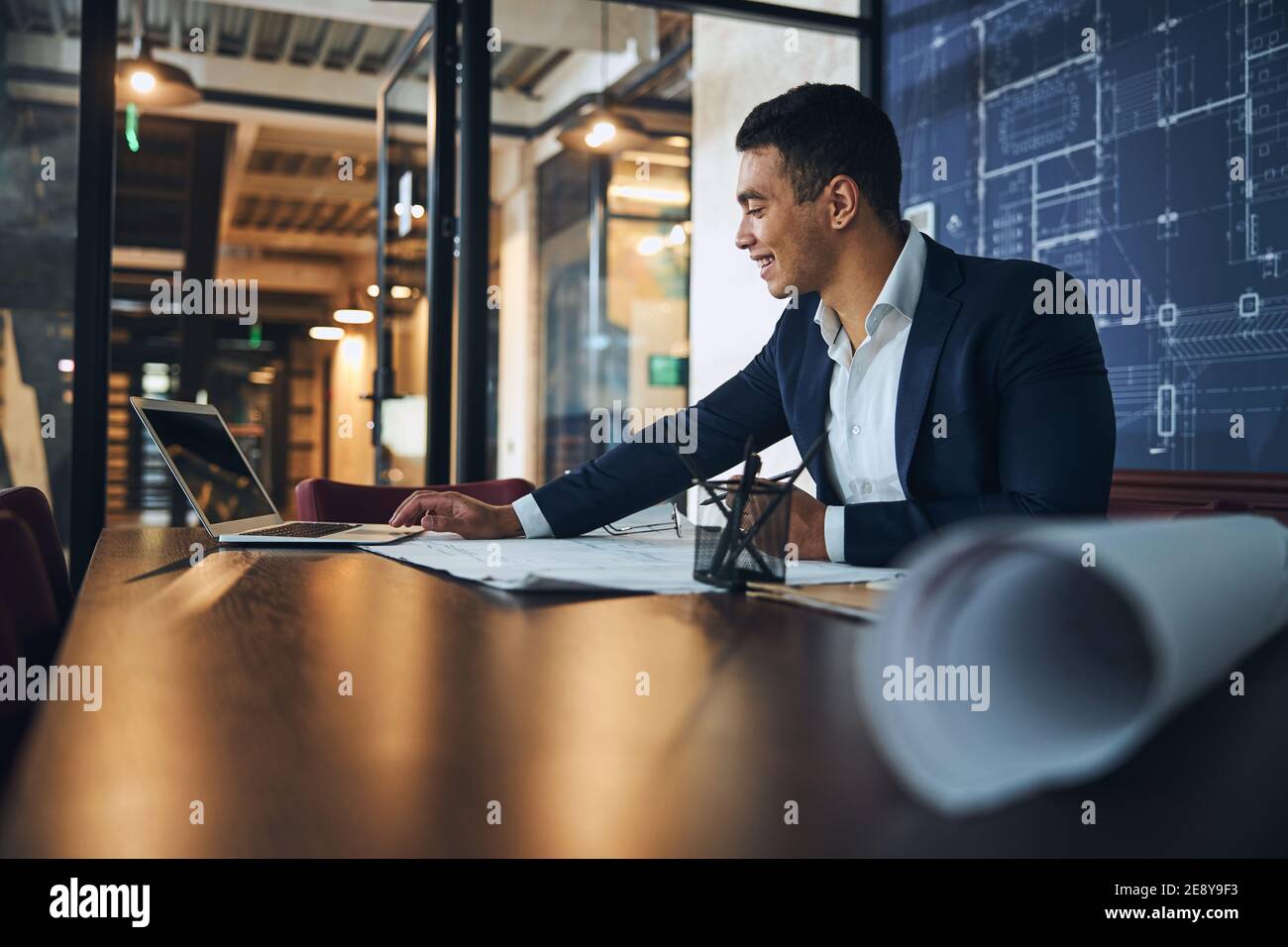 Joyful young draftsman making an engineering drawing Stock Photo - Alamy