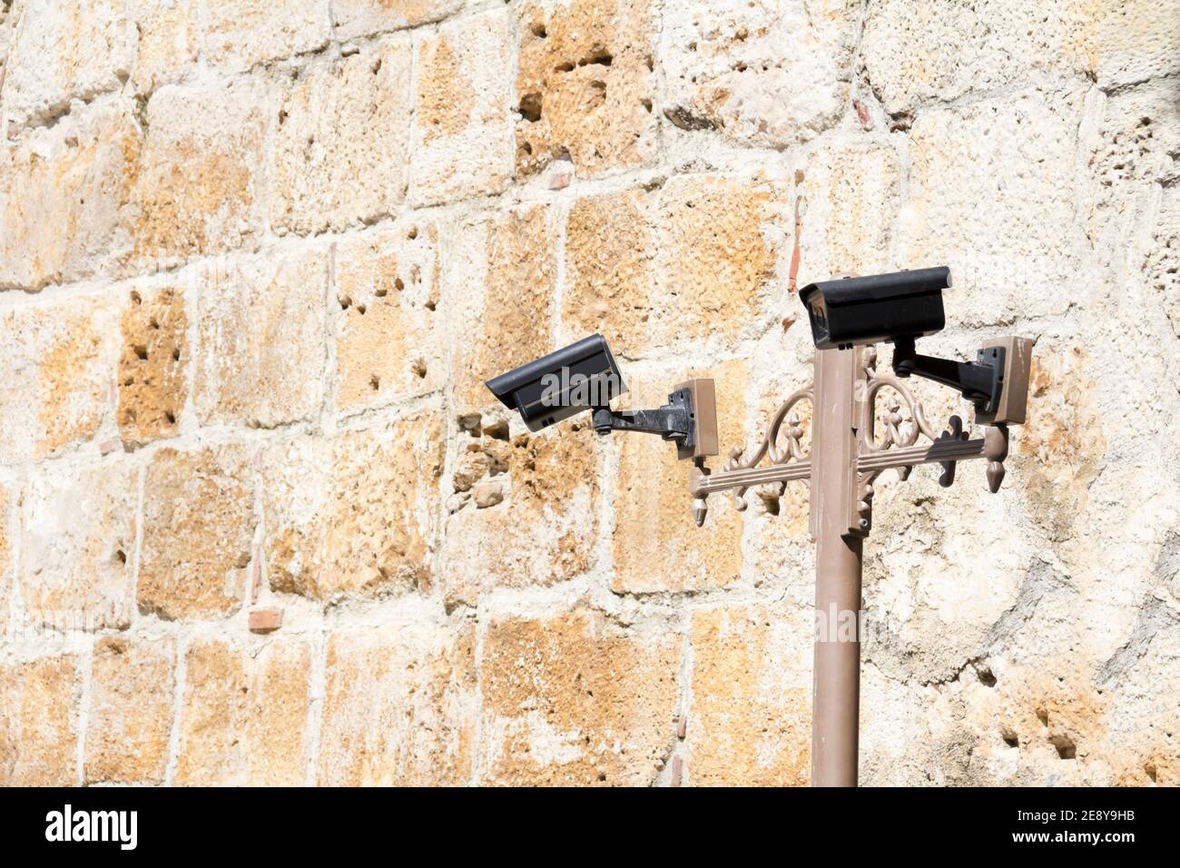 Security camera attached to the wall Stock Photo - Alamy