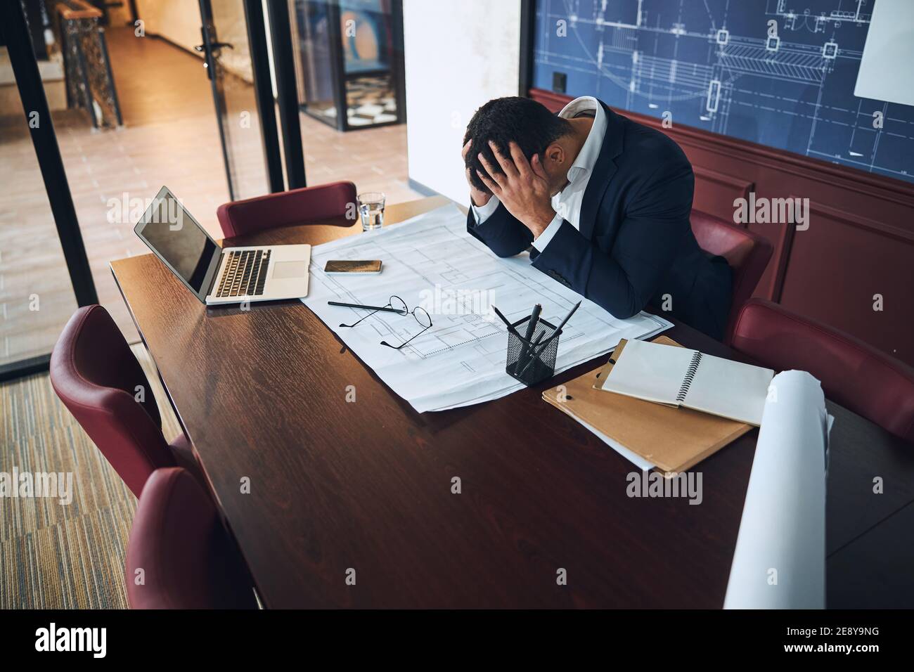 Engineer suffering from an attack of migraine in his office Stock Photo ...