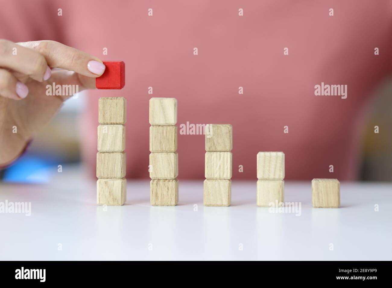 Female hand drawing graph from wooden toy cubes Stock Photo - Alamy