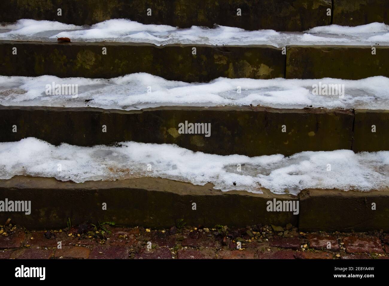 Snow and ice covered stairs in winter with footprints Stock Photo - Alamy
