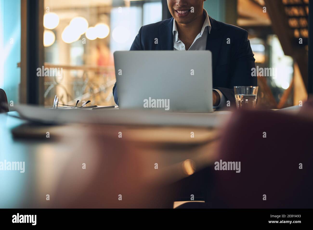 Man with a pleased smile working on his computer Stock Photo - Alamy