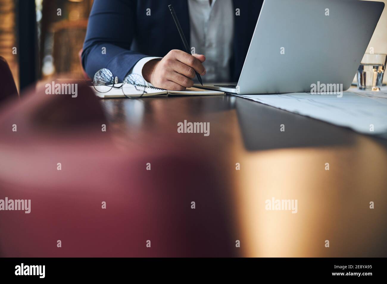 Engineering draftsman in a stylish jacket sitting before the computer ...