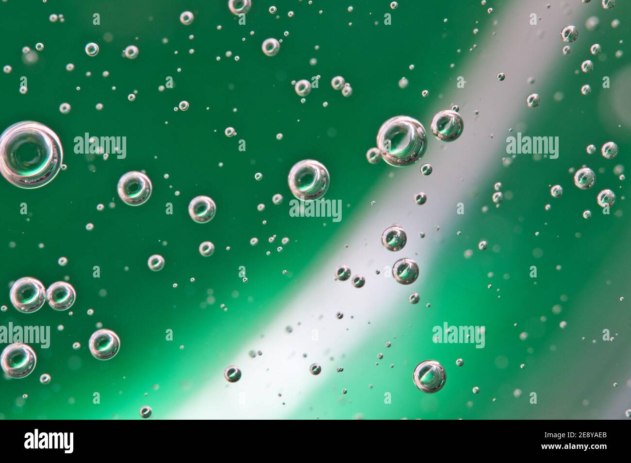 Oxygen in liquid. Bubbles . Background green. Macro Stock Photo - Alamy