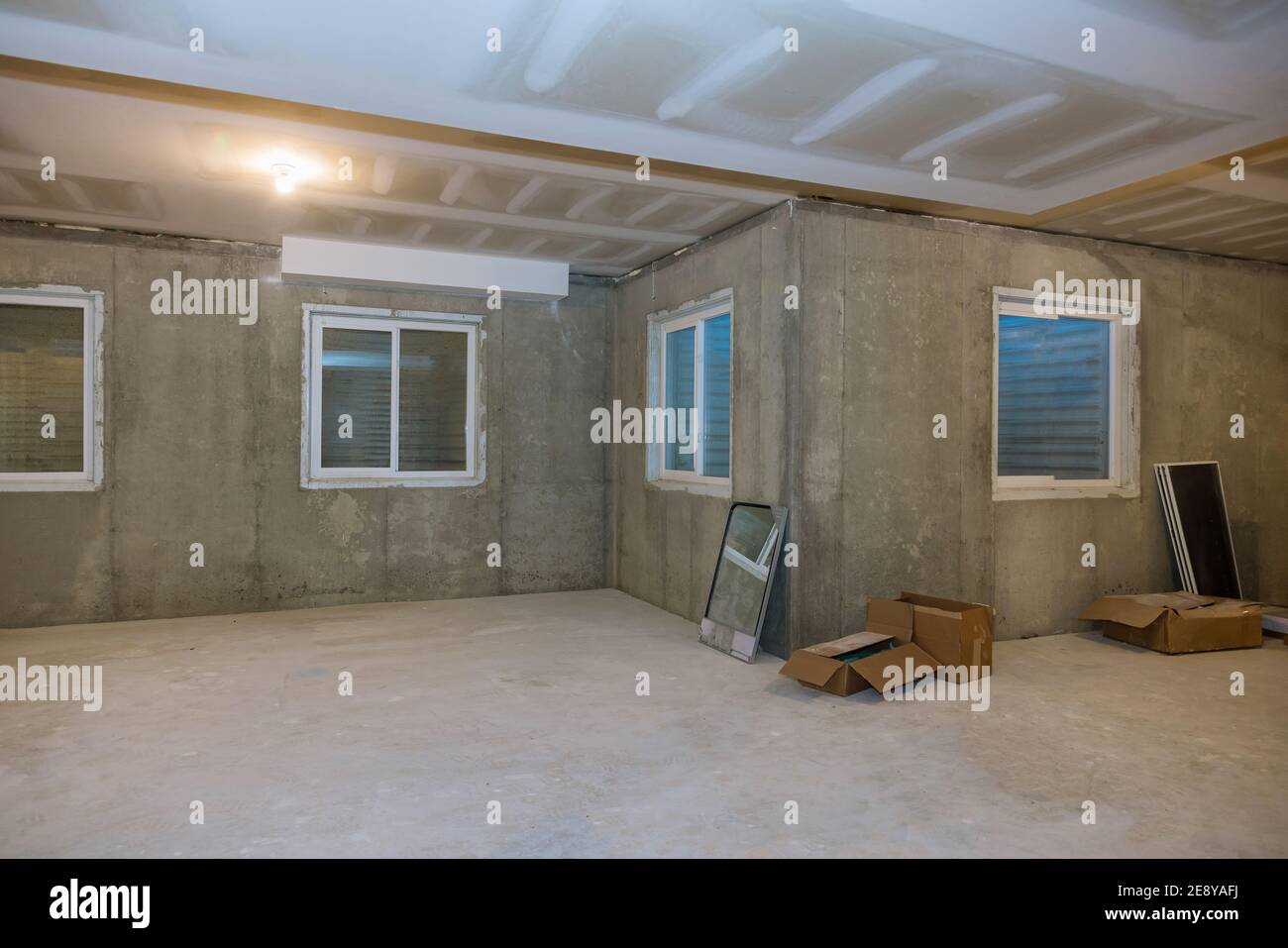 Unfinished view on concrete floor construction of basement empty under ...