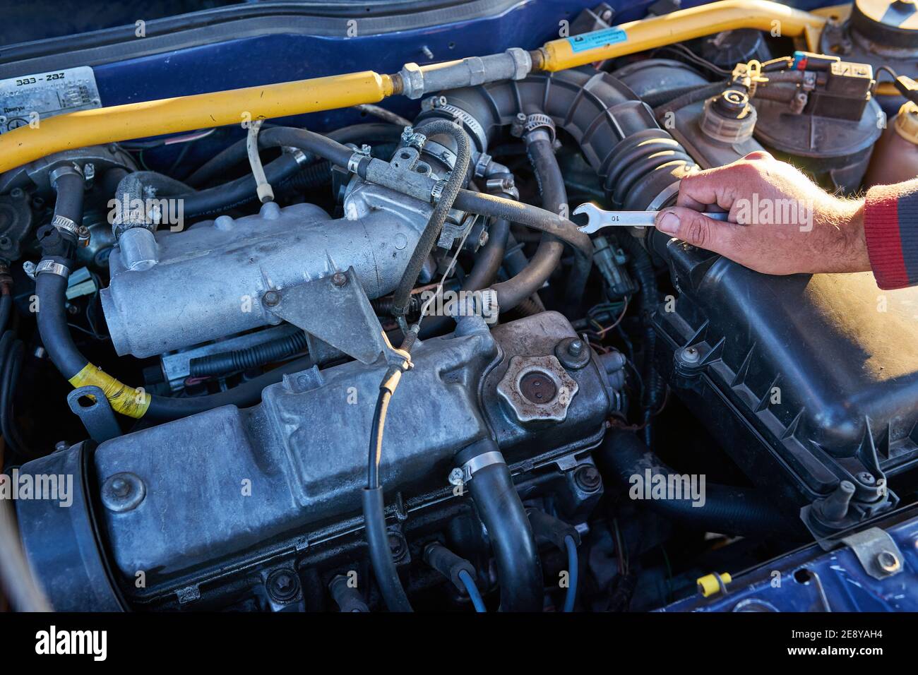Tired man tries to repair a broken car Stock Photo - Alamy