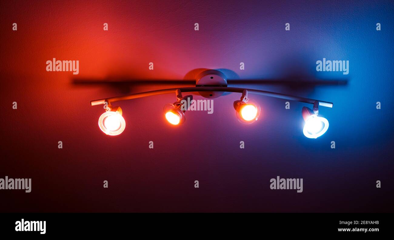 red and blue light bulbs on the ceiling Stock Photo - Alamy
