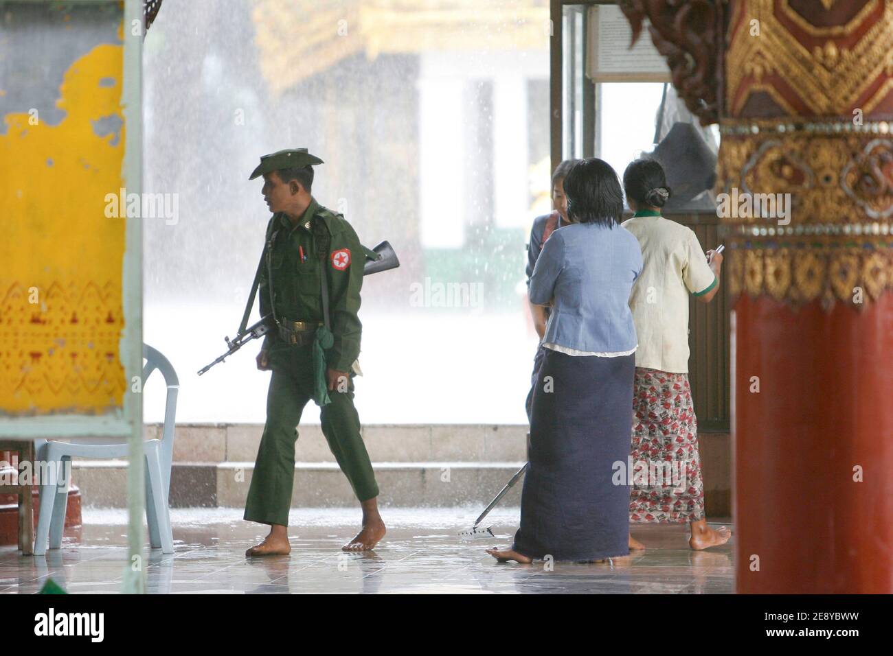 A soldier carrying a weapon guards the entrance of he Shwedagon, the ...