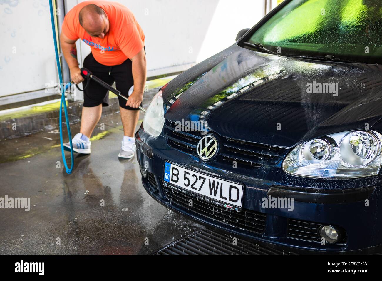 Washing and cleaning car in self service car wash station. Car washing using high pressure water ...