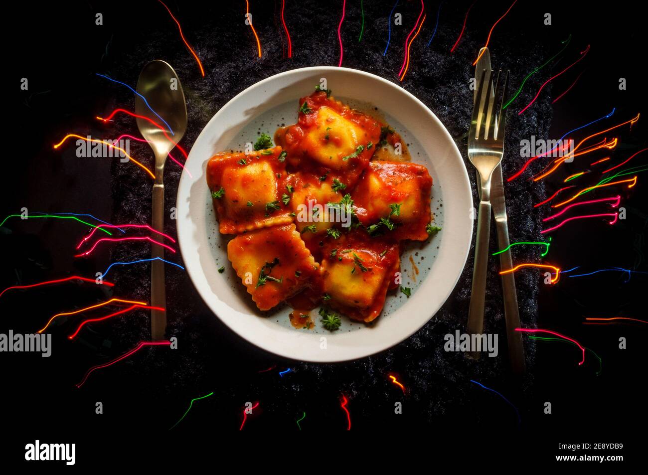 Italian ravioli with tomato sauce exciting celebration with neon light ...